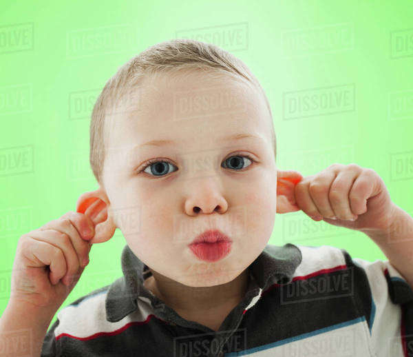 Caucasian boy pulling his ears - Stock Photo - Dissolve