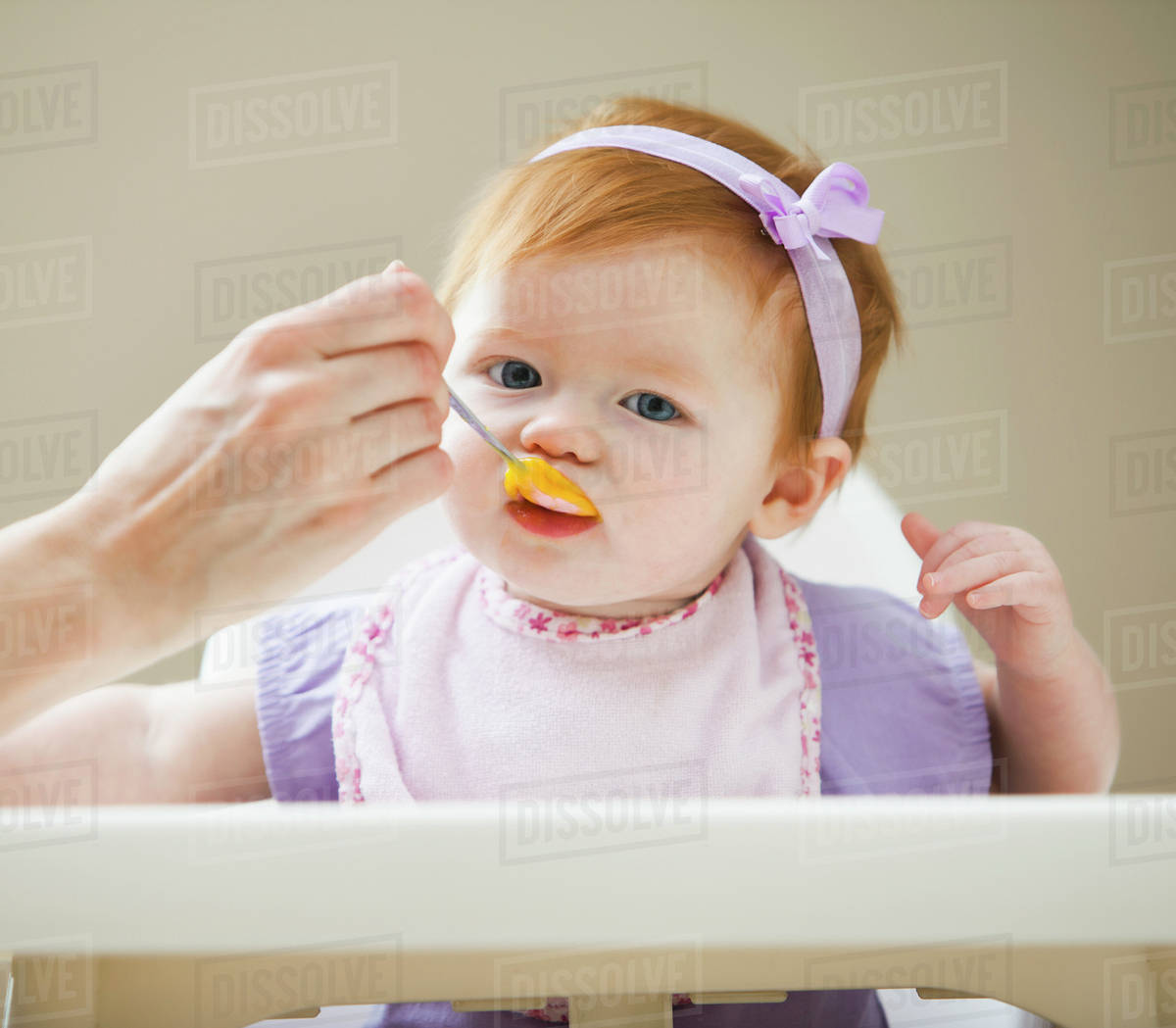 Caucasian mother feeding baby girl - Royalty-free Stock Photo | Dissolve