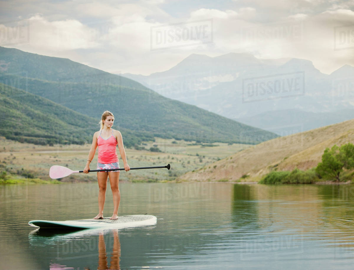 Caucasian woman on stand up paddle board - Stock Photo - Dissolve