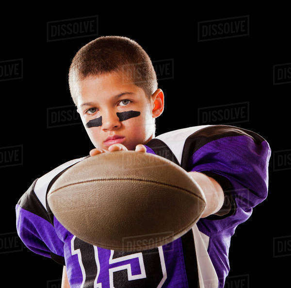 Mixed race football player holding football - Royalty-free Stock Photo ...