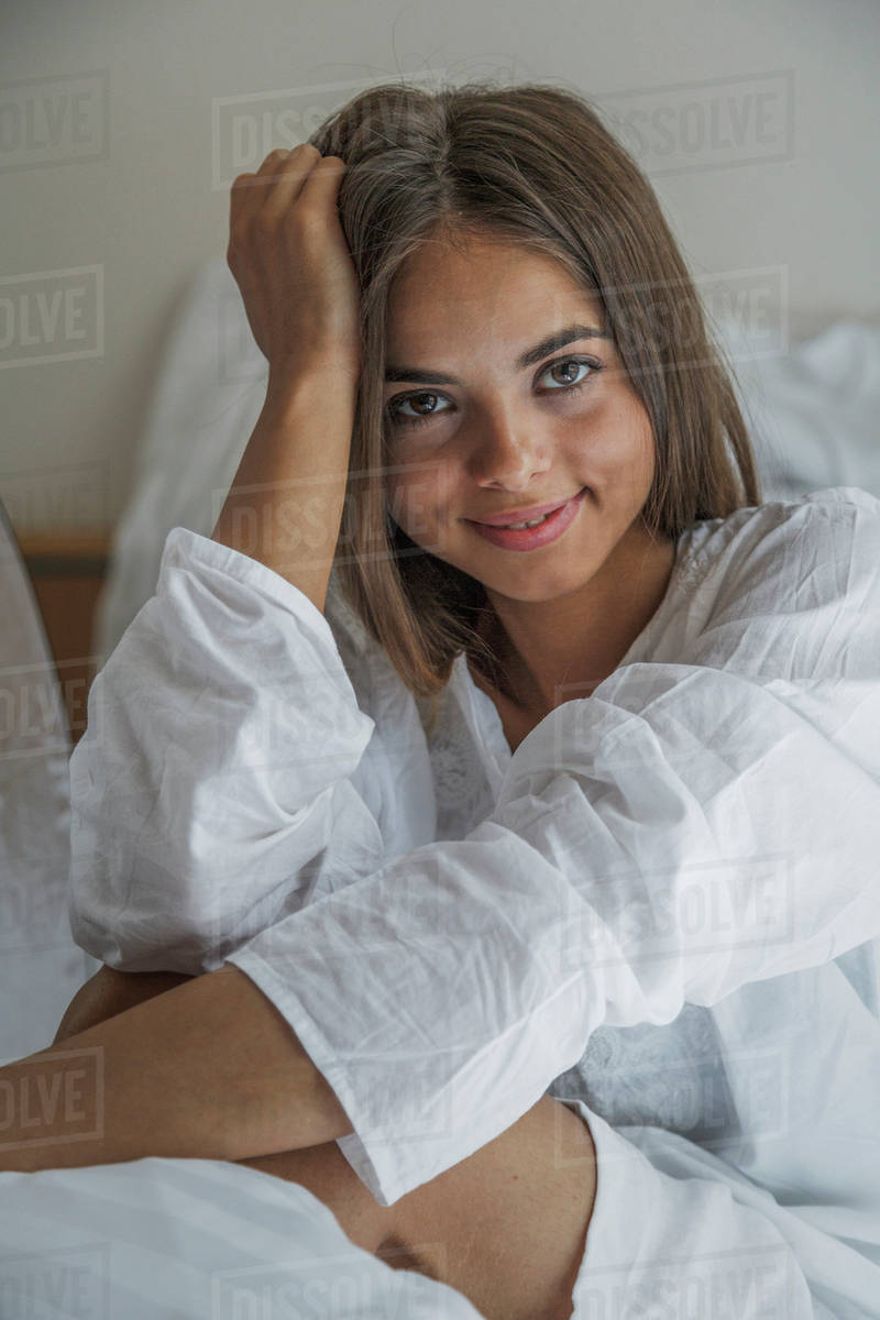 Caucasian woman smiling in bed - Royalty-free Stock Photo | Dissolve