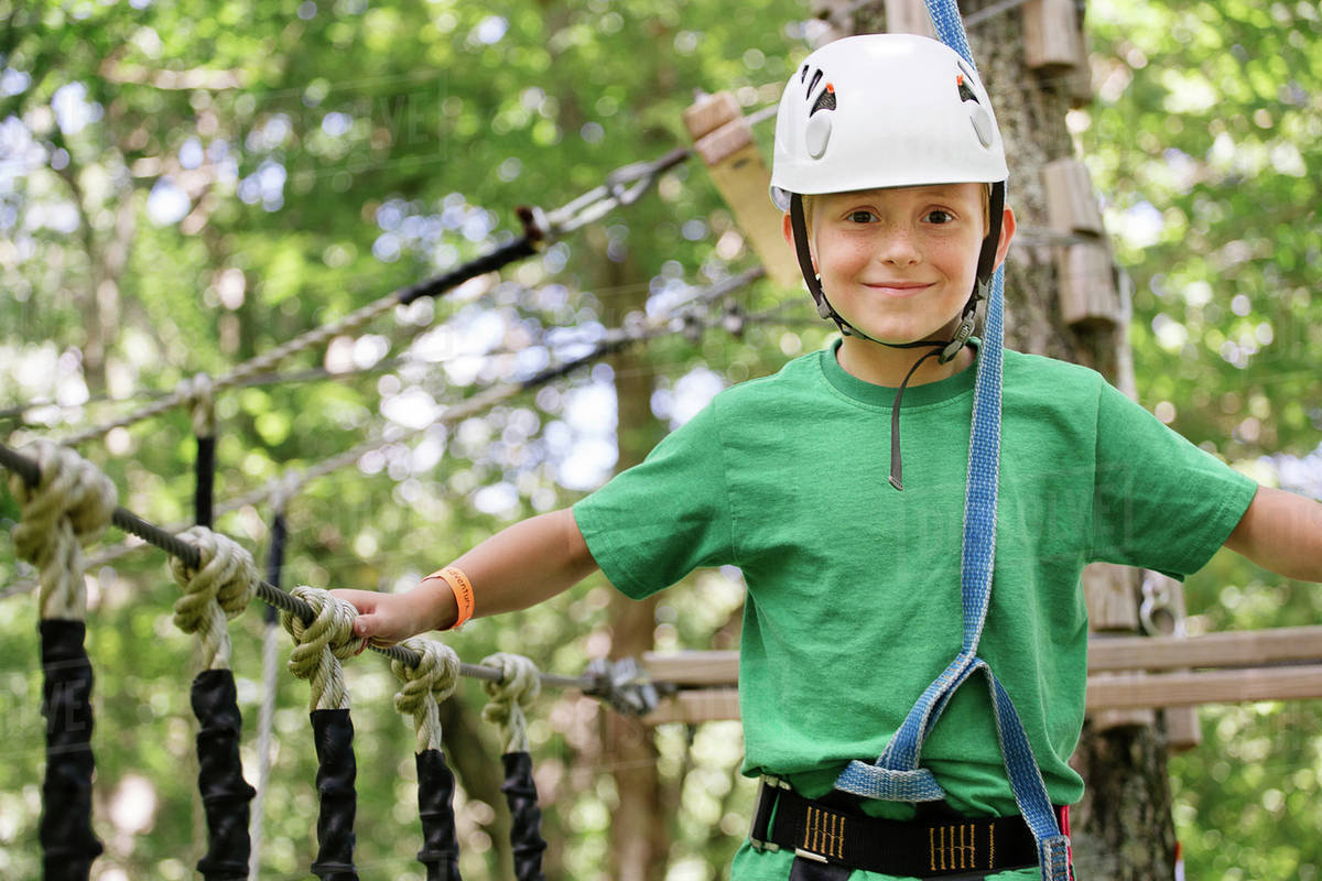 Caucasian boy balancing on rope bridge - Royalty-free Stock Photo ...