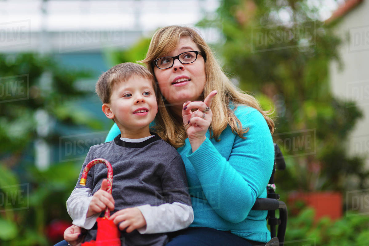 Paraplegic mother and son exploring outdoors - Royalty-free Stock Photo ...
