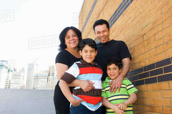 Hispanic family hugging outdoors - Royalty-free Stock Photo | Dissolve