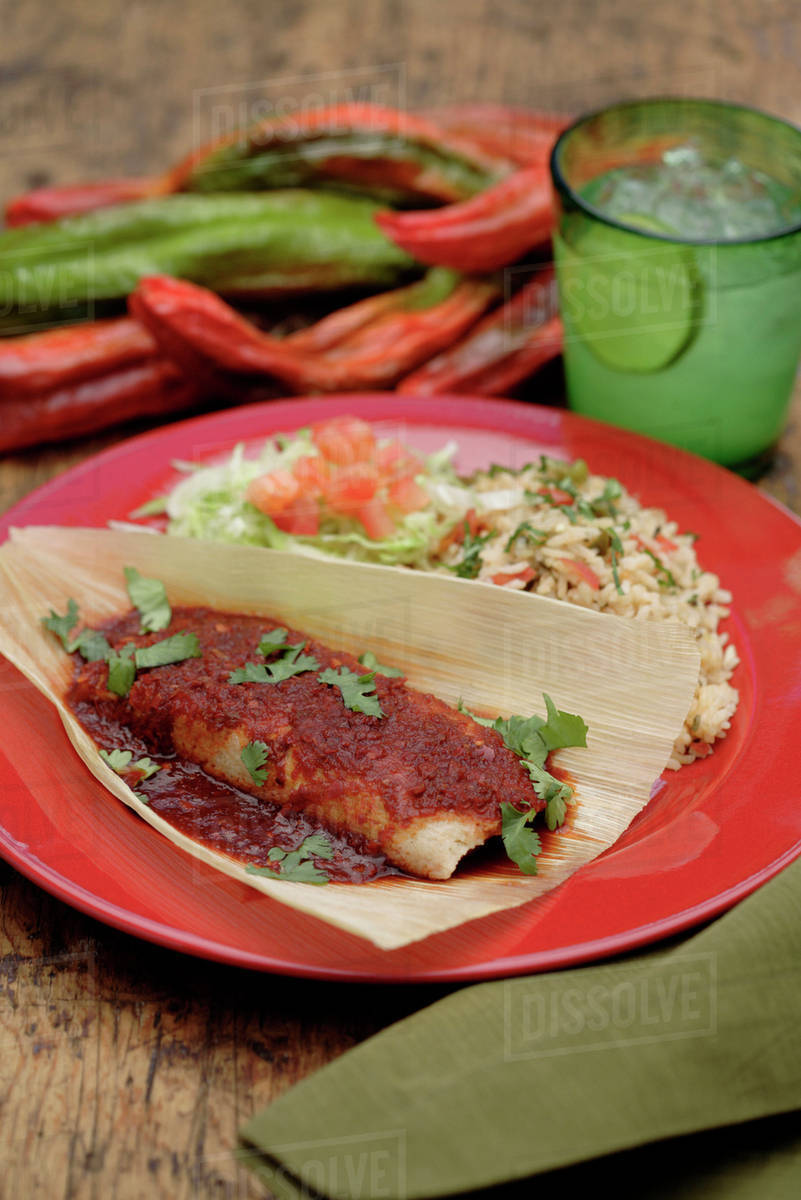 Tamale with red sauce on plate - Royalty-free Stock Photo | Dissolve