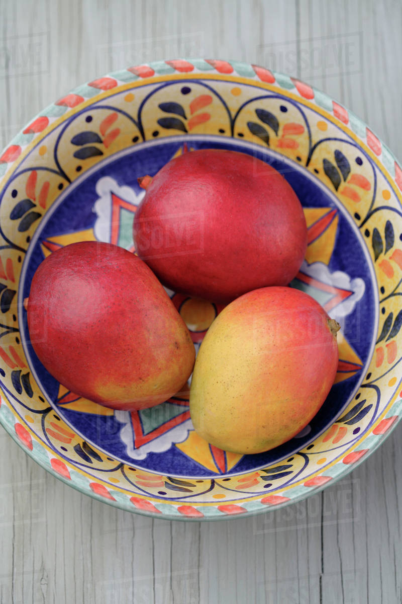 Mexican mangoes in bowl - Stock Photo - Dissolve