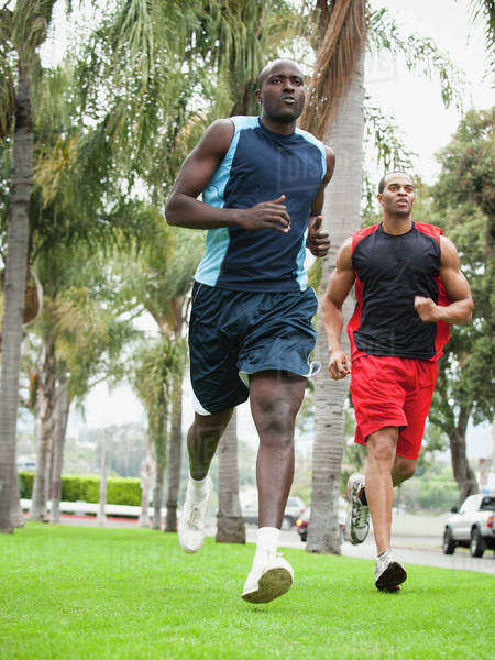 Men running in park together - Royalty-free Stock Photo | Dissolve