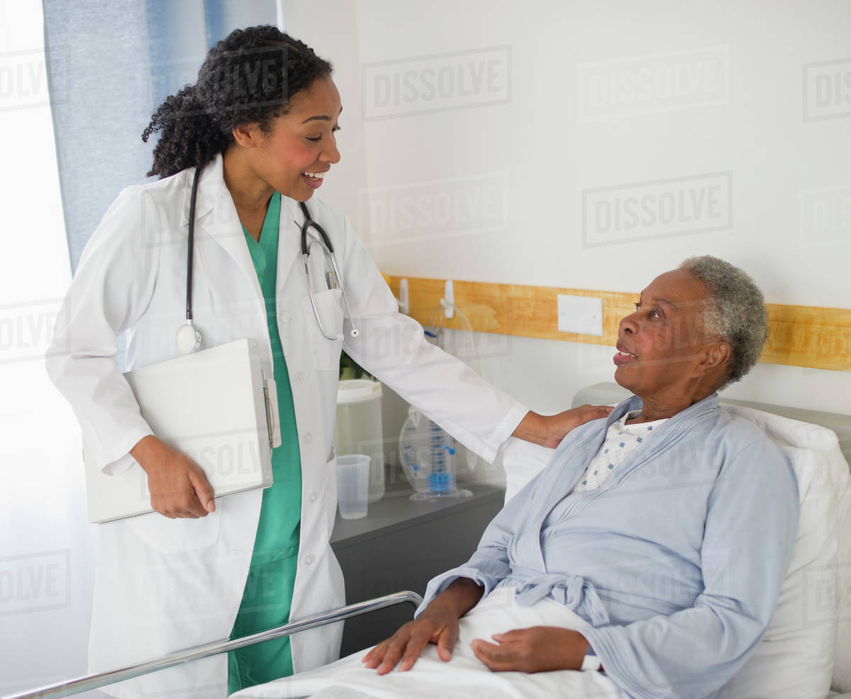Doctor checking on patient in hospital - Stock Photo - Dissolve