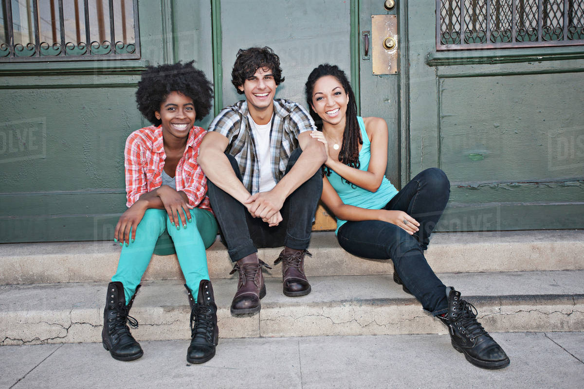 Friends hanging out on front stoop - Royalty-free Stock Photo | Dissolve