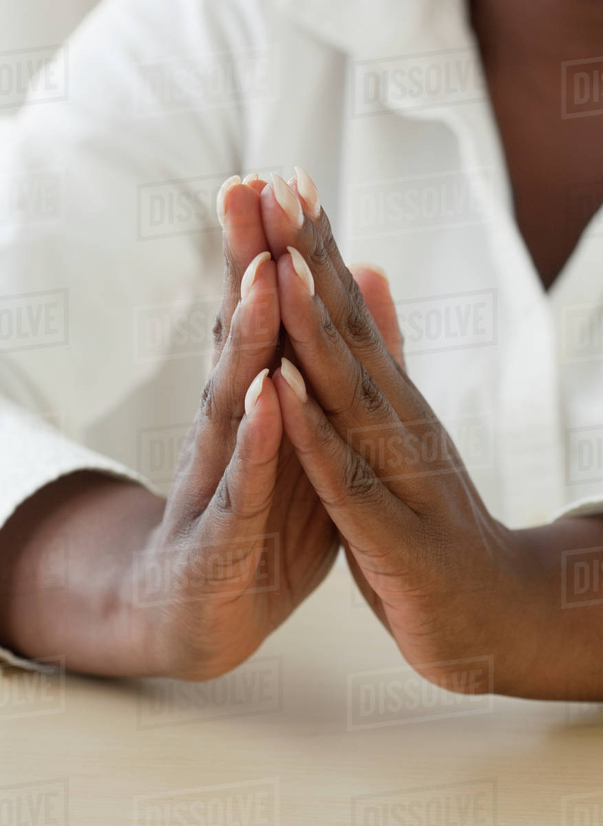 African woman praying - Royalty-free Stock Photo | Dissolve