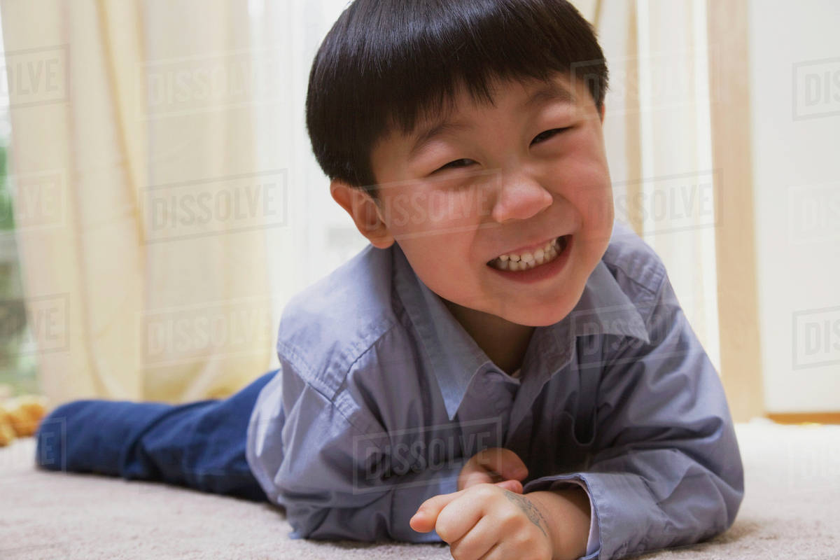 Korean boy grinning - Royalty-free Stock Photo | Dissolve