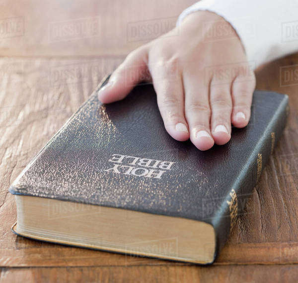 Woman's hand on Bible - Royalty-free Stock Photo | Dissolve