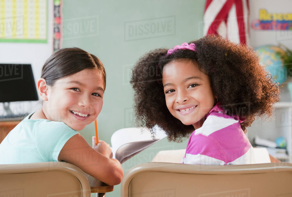 School girls smiling in classroom - Royalty-free Stock Photo | Dissolve