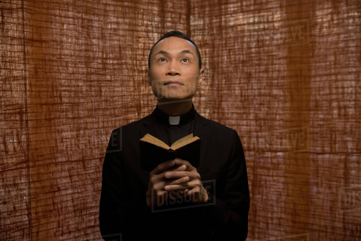 Pacific Islander priest praying - Royalty-free Stock Photo | Dissolve
