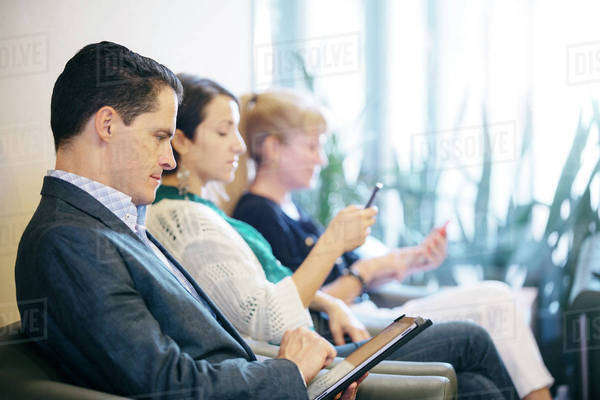 Business people waiting in office lobby - Royalty-free Stock Photo ...