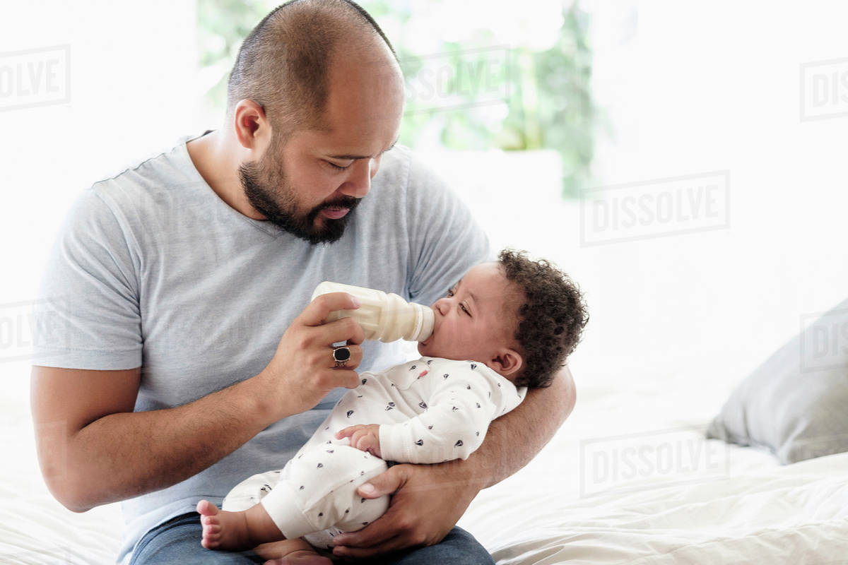 Father bottle feeding baby son - Royalty-free Stock Photo | Dissolve