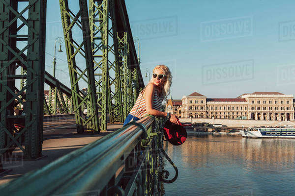 Caucasian woman standing on bridge - Royalty-free Stock Photo | Dissolve