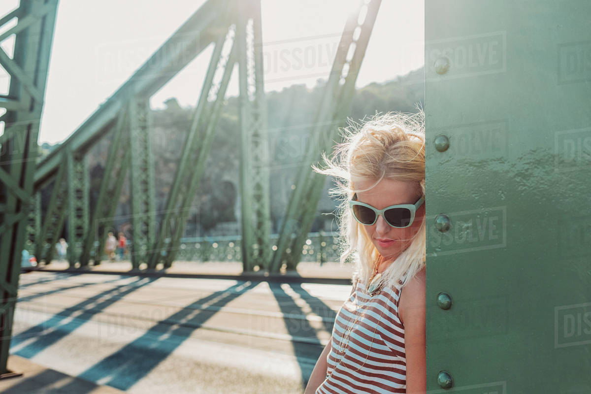 Caucasian woman standing on bridge - Royalty-free Stock Photo | Dissolve