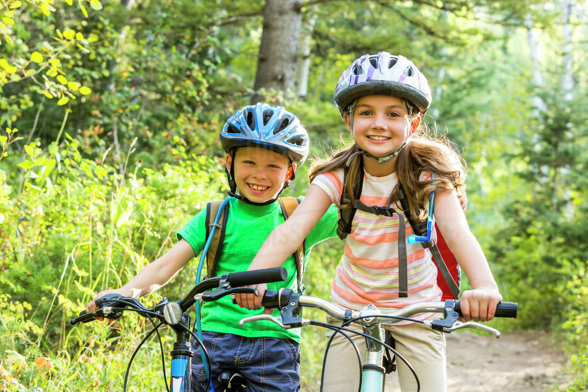 Caucasian children riding mountain bikes - Stock Photo - Dissolve