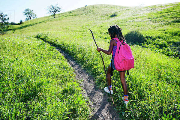 Black girl walking on rural path - Royalty-free Stock Photo | Dissolve