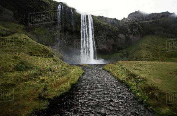 Waterfall pouring over rocky cliff - Royalty-free Stock Photo | Dissolve