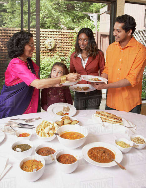 Indian family at dinner table - Stock Photo - Dissolve
