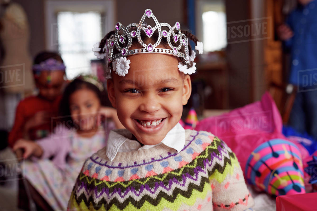 Smiling girl wearing tiara at party - Royalty-free Stock Photo | Dissolve