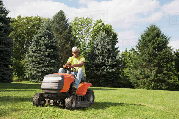 African American man mowing lawn - Royalty-free Stock Photo | Dissolve