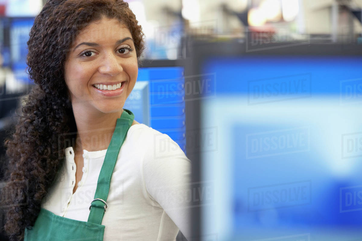 Mixed Race cashier wearing apron - Royalty-free Stock Photo | Dissolve