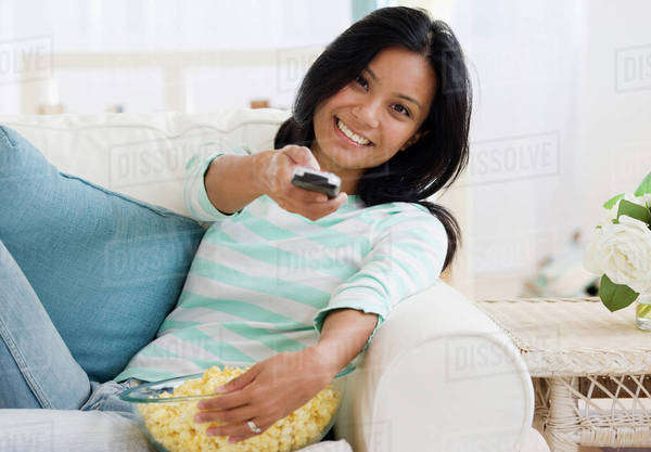 Pacific Islander woman pointing remote control - Royalty-free Stock ...
