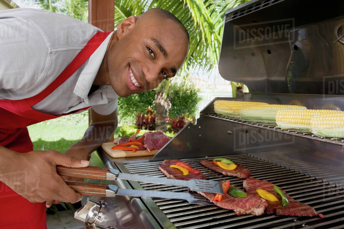 African man barbecuing - Royalty-free Stock Photo | Dissolve