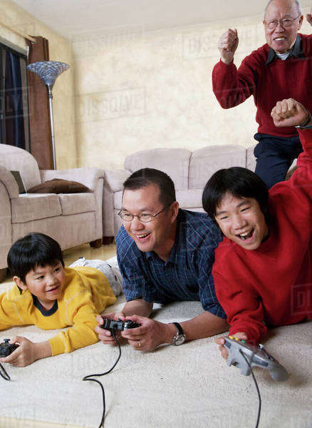 Multi-generational Asian family playing video games - Stock Photo ...