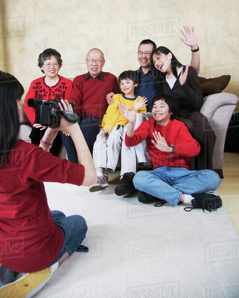 Multi-generational Asian family being video recorded - Royalty-free ...