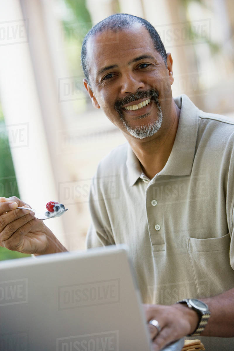 African man eating breakfast - Royalty-free Stock Photo | Dissolve
