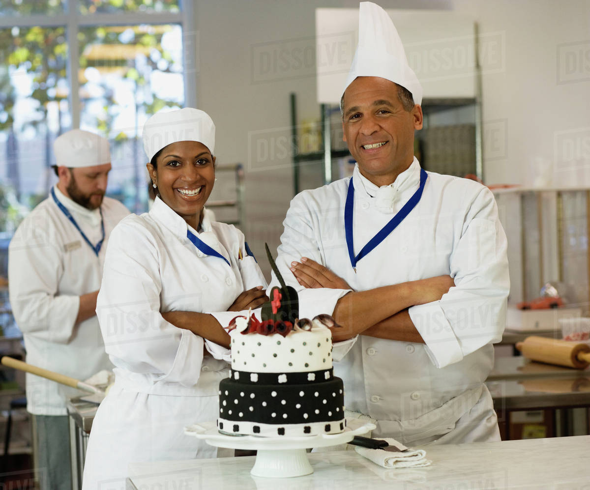 Multi-ethnic pastry chefs next to cake - Royalty-free Stock Photo ...