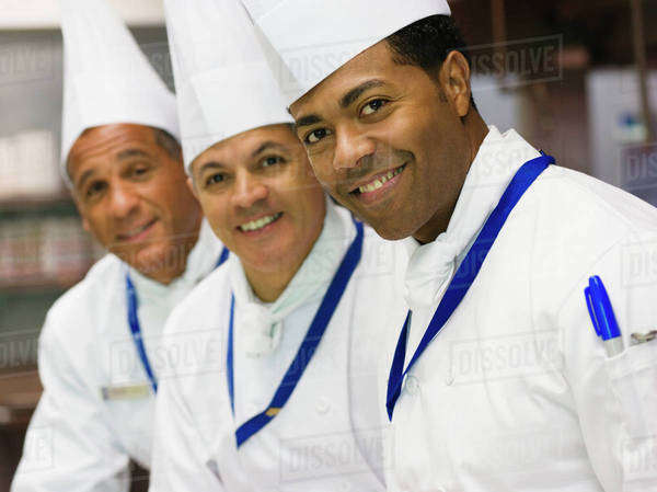 Multi-ethnic male chefs in a row - Stock Photo - Dissolve