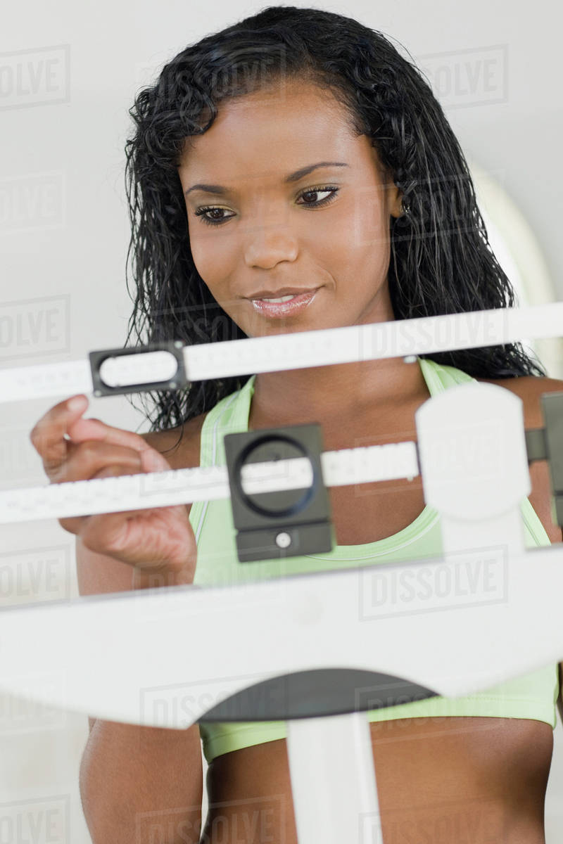 Panamanian woman on scale - Stock Photo - Dissolve