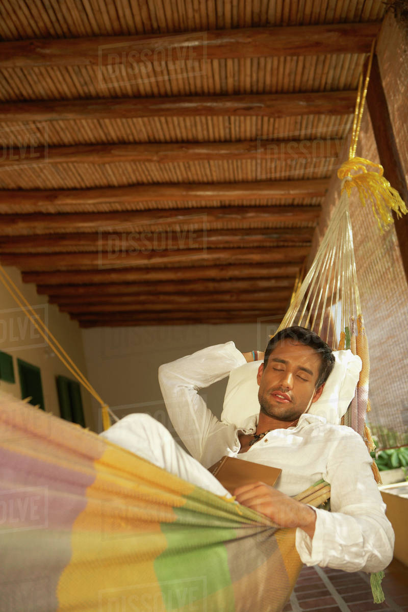 Man laying in hammock - Royalty-free Stock Photo | Dissolve