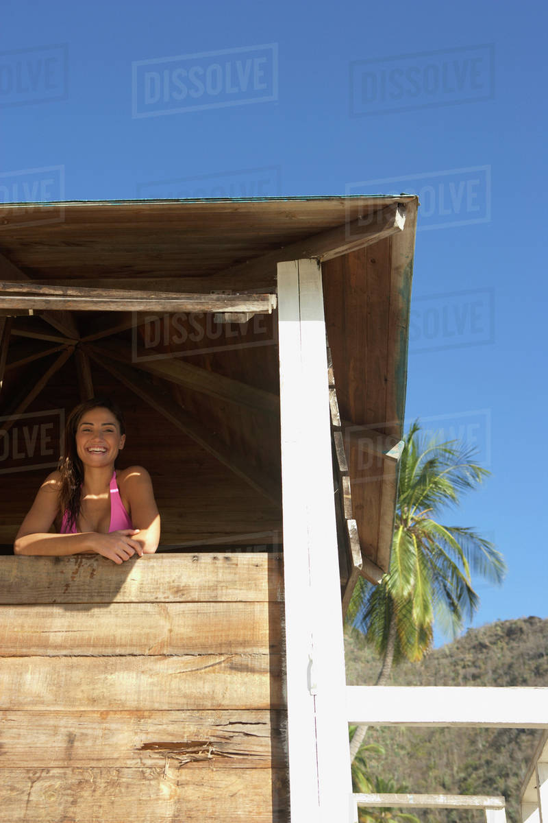 Woman in lifeguard tower at beach - Stock Photo - Dissolve