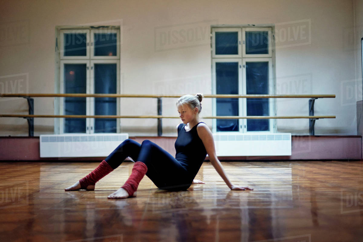 Caucasian dancer sitting on studio floor - Royalty-free Stock Photo ...