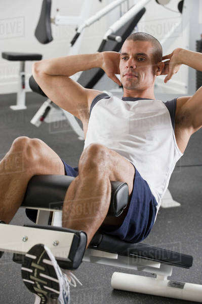 Hispanic man exercising in gym - Royalty-free Stock Photo | Dissolve