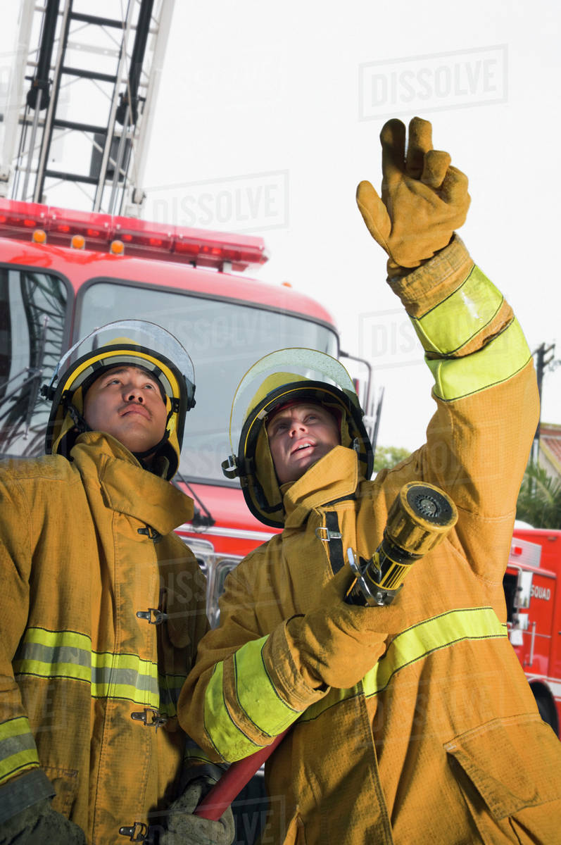 Firefighters putting out fire - Royalty-free Stock Photo | Dissolve