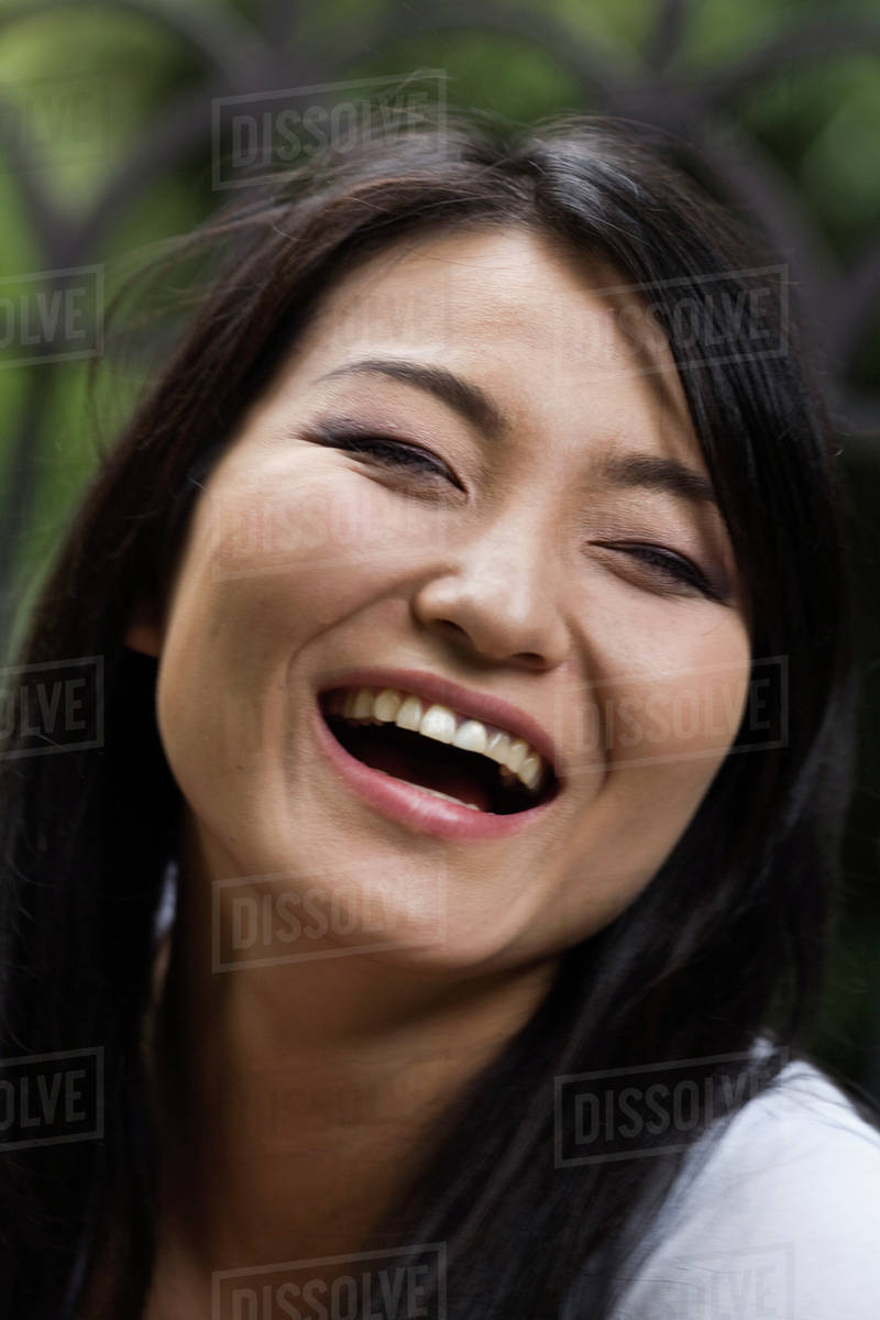 Confident Japanese woman laughing - Royalty-free Stock Photo | Dissolve