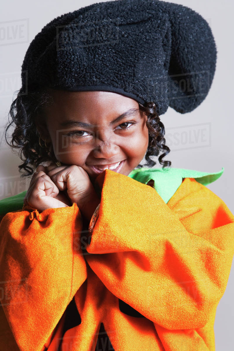 African girl wearing pumpkin costume - Stock Photo - Dissolve