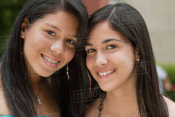 Hispanic sisters smiling - Royalty-free Stock Photo | Dissolve