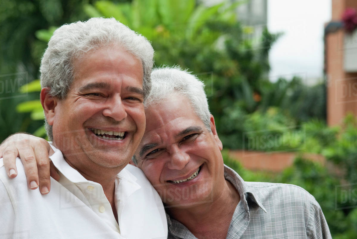 Smiling Hispanic men hugging - Royalty-free Stock Photo | Dissolve