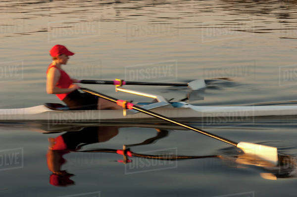 Person rowing sculling boat on river - Royalty-free Stock Photo | Dissolve