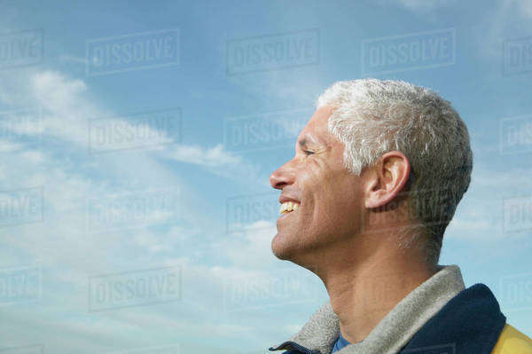 Profile of middle-aged man under blue sky - Royalty-free Stock Photo ...