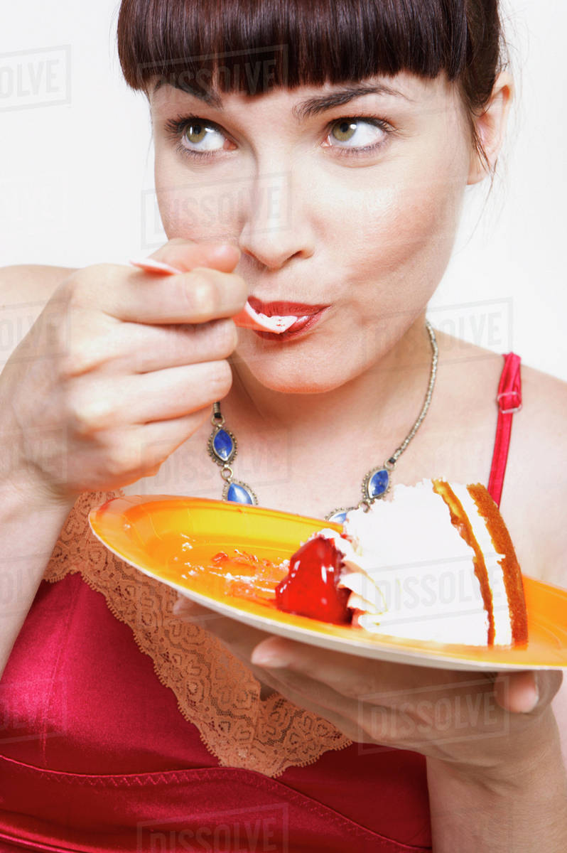 Close up of woman eating cake - Royalty-free Stock Photo | Dissolve