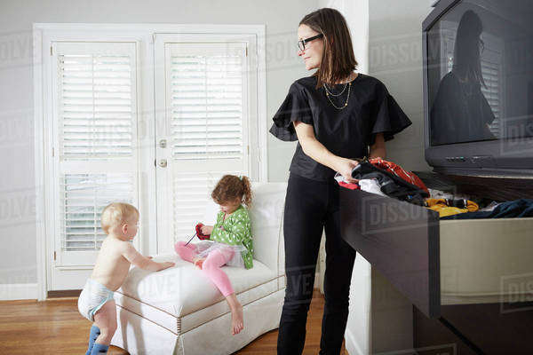 Caucasian mother watching children playing - Stock Photo - Dissolve